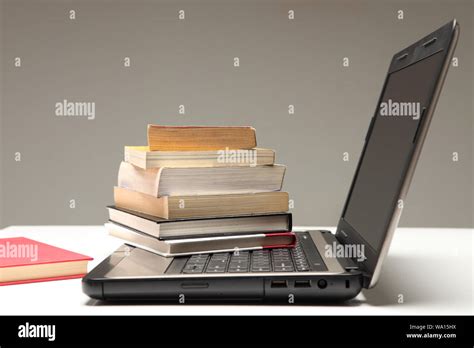 Laptop With A Stack Of Books Stock Photo Alamy