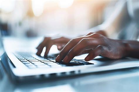 A Person Is Typing On A Laptop With Their Hands On The Keyboard
