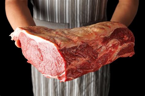 Butcher Holding With Hands A Large Piece Of Beef Sirloin Steaks Stock