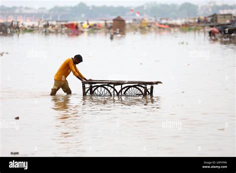 People Moves To A Safer Place On A Submerged Road At The Bank Of Sangam