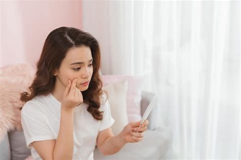 Premium Photo Asian Woman Look Mirror With Acne Problem At Home