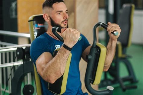 Premium Photo A Young Athlete Trains In The Gym Bodybuilder Trains
