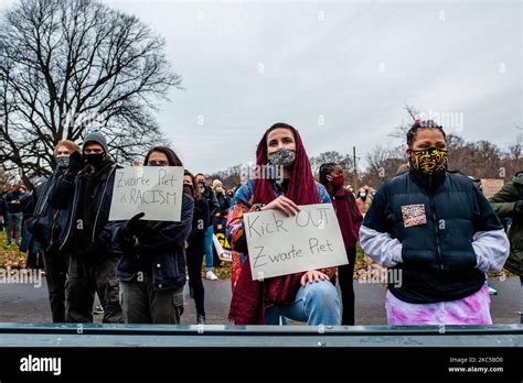 A Group Of People Are Holding Placards Against Racism During The