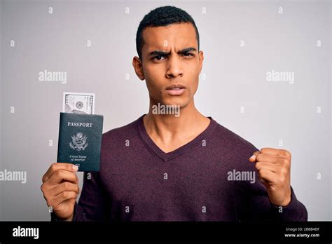 Young Handsome African American Tourist Man Holding Passport With