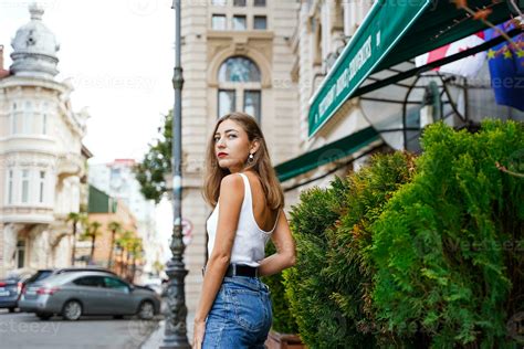 Girl Walking Around City On Background Of Beautiful Architectural