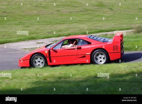 Classic Red Ferrari F40 Supercar Driving Fast On A Uk Country Road