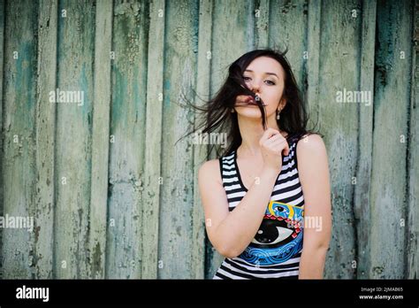 Brunette Model Girl At Dress With Stripes Background Cian Wooden