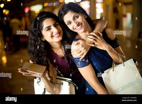 Two Beautiful Indian Women Enjoying The Night In Shopping And Laughing