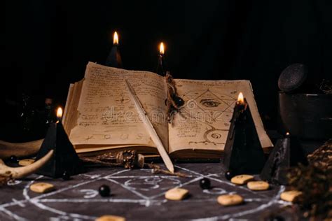 Open Old Book With Magic Spells Runes Black Candles On Witch Table