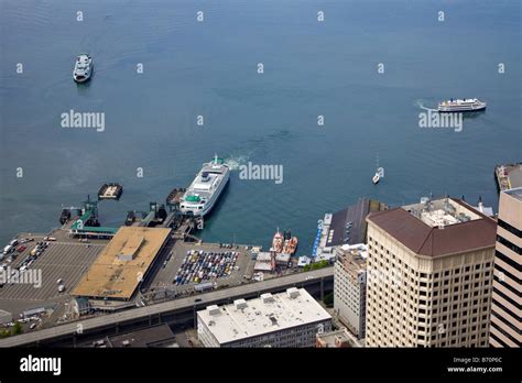 Aerial View Of Ferry Boat Entering Terminal Along Waterfront Of Seattle