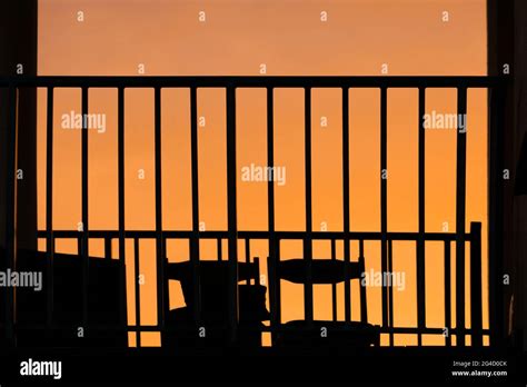 Abstract Composition Of Metallic Balcony Black Fence And Chairs
