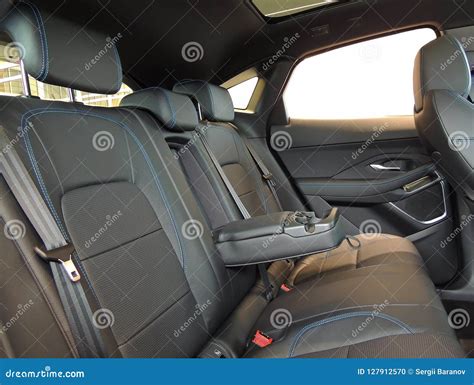 Leather Trimmed Folding Armrest With Cup Holders In Rear Seats Inside A