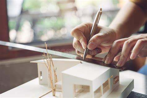 Closeup Image Of An Architect Measure Scale Of A Mass Model On Table