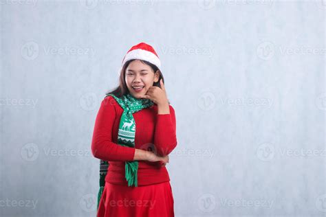 Gesture Of Young Asian Girl Wearing Christmas Sweater Santa Hat And