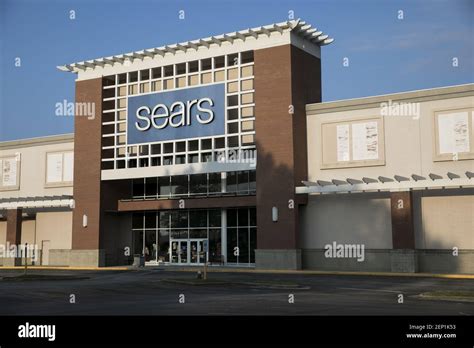 A Logo Sign Outside Of A Sears Retail Store Location In Greensboro