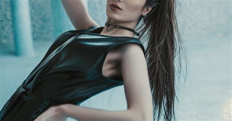 Woman In Black Sleeveless Dress Posing In A Bending Position · Free