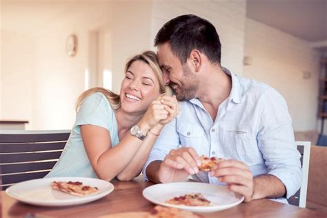 Premium Photo Young Couple Enjoying Eating Pizza