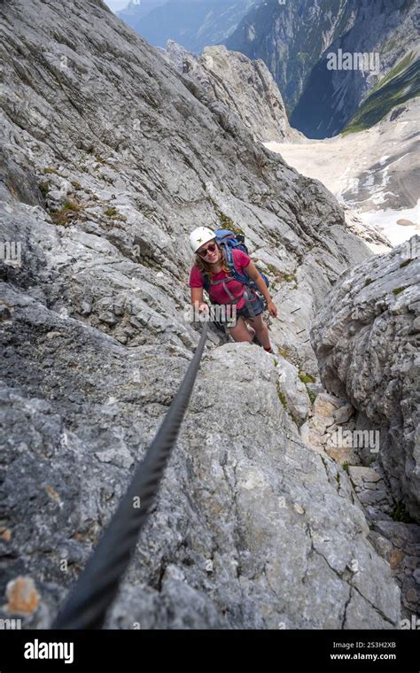 Mountaineer With Helmet Climbing In A Secured Via Ferrata Zugspitze