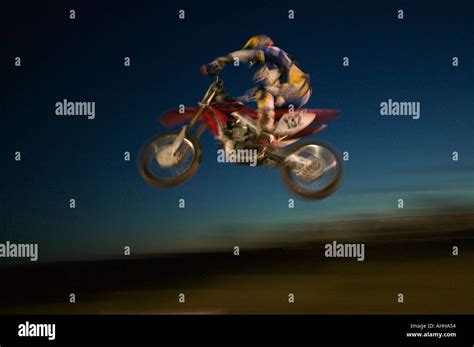 A Dirt Bike Goes Airborne During A Jump On A Motocross Course In