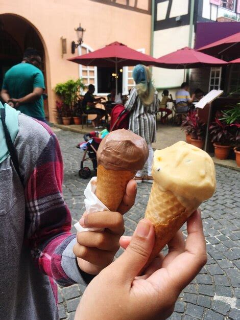 Premium Photo People Holding Ice Cream Cones In City
