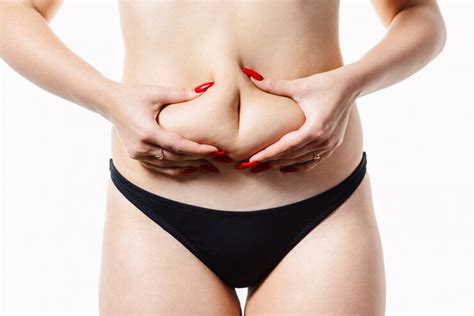 Premium Photo Woman Holds A Fold Of Fat On Her Waist Conceptual