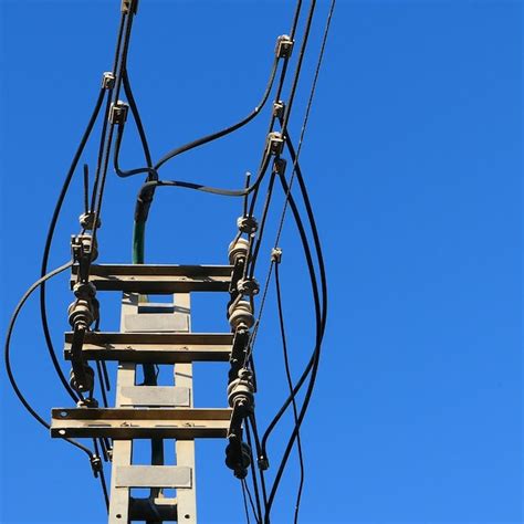 Premium Photo Power Line Against Clear Blue Sky