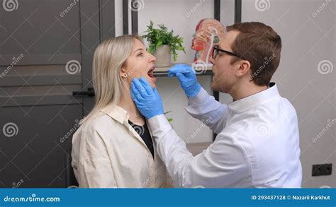 Ent Doctor Doing Throat Exam Of A Woman Patient Opened Her Mouth To