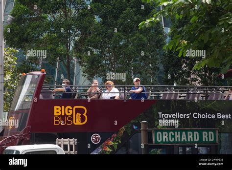 Tourists Sitting On A Big Bus Tour On The Second Level Open Top To