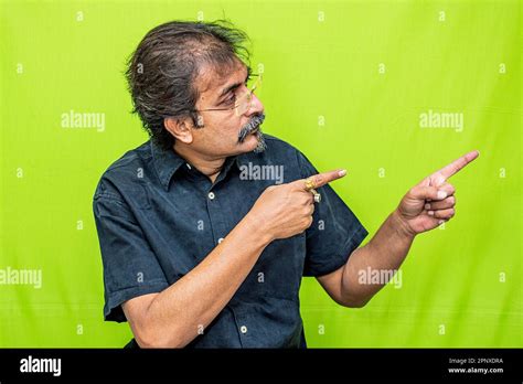 A Smart Corporate Businessman In Black Shirt Pointing Top Right With