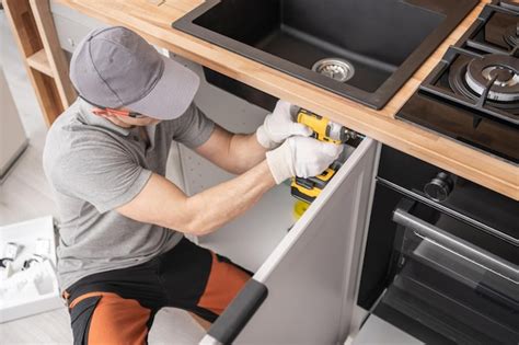 Premium Photo Cabinetmaker Assembling Kitchen Cabinets Furniture