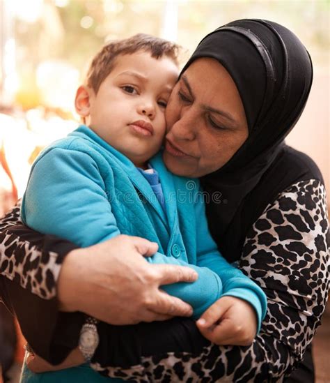 Grandmas Little Angel A Mature Muslim Woman Sitting With Her Grandson