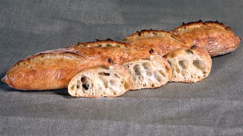 Long Cut White Bread Lies On A Grey Linen Tablecloth Stock Image
