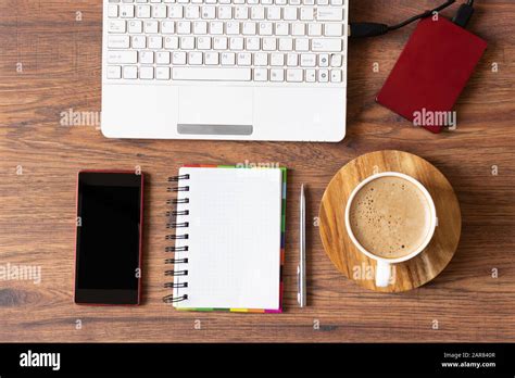 Workspace With Laptop Diary And A Cup Of Coffee On Wooden Background