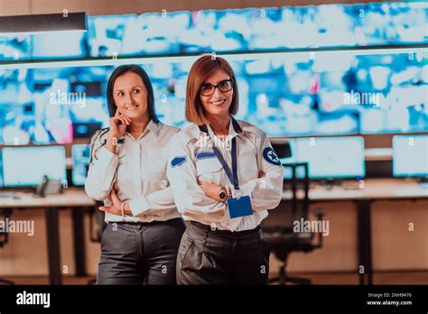 Group Portrait Of Female Security Operator While Working In A Data System Control Room Offices
