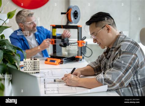 Architects Working With 3D Printer And Projecting House Model Drawing