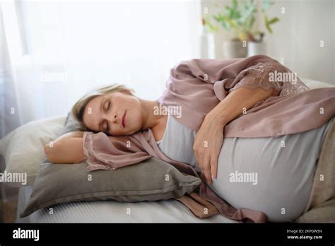 Pregnant woman sleeping and resting in her bed Stock Photo - Alamy