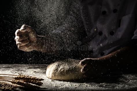 Man Preparing Bread Dough On Wooden Table In A Bakery Close Up