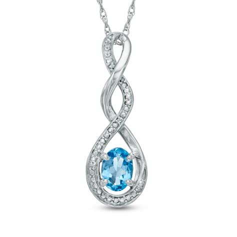 Oval Blue Topaz And Diamond Accent Infinity Twist Pendant In Sterling