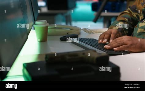 Military Officer Making Telephone Call To Relay Enemy Info Gained Using