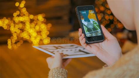 Woman Using Smartphone With Augmented Reality App And Placing Virtual