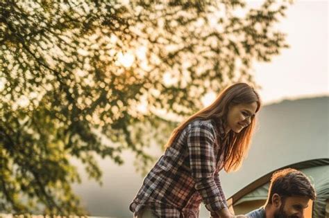 Premium Photo Couple Building Tent In A Campsite Near To Lake