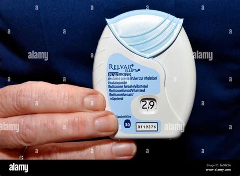 Asthma Inhaler Nurse Holding An Inhaler Used To Deliver The Combination Drug Fluticasone