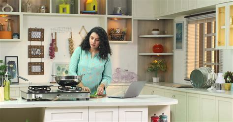 Happy Woman Watching Video Recipe On Laptop While Cooking Healthy Lunch