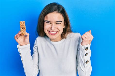 Young Caucasian Girl Eating Protein Bar As Healthy Energy Snack