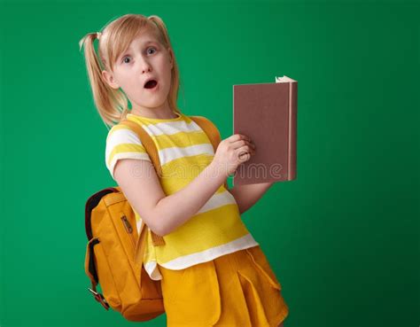 Surprised School Girl With Open Book On Green Background Stock Image