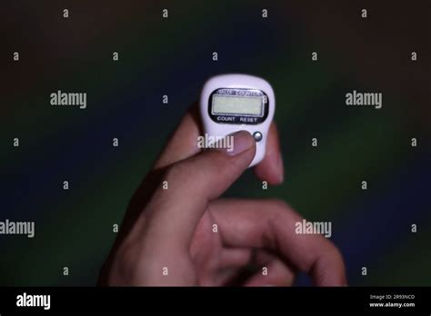 Tally Counter In Hand Of Male Doing Dhikar With Digital Tally Counter Tasbih Islamic Background