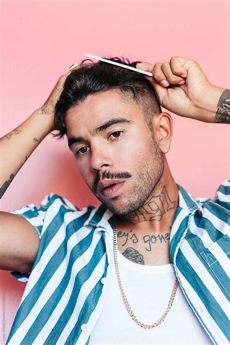 Cool Latino Man Combing His Hair By Stocksy Contributor Lucas Ottone