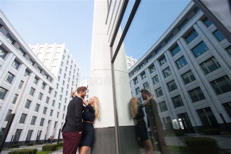 Guy Hugging A Girl In The City On The Background Of Buildings The