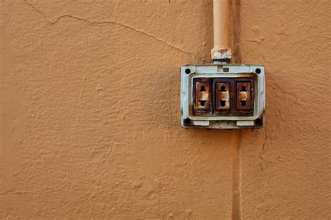 Premium Photo The Old Rusty Electrical Switch On A Wall