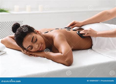 Therapist Placing Hot Stones On Black Girl Back Stock Image Image Of